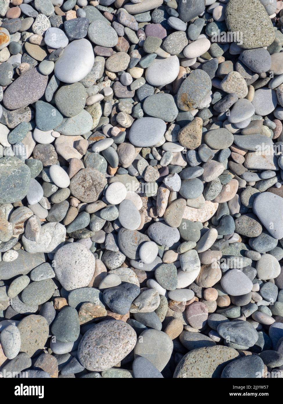 Lots of rubble. Pebble coast. Background from pebbles. Smooth little ...