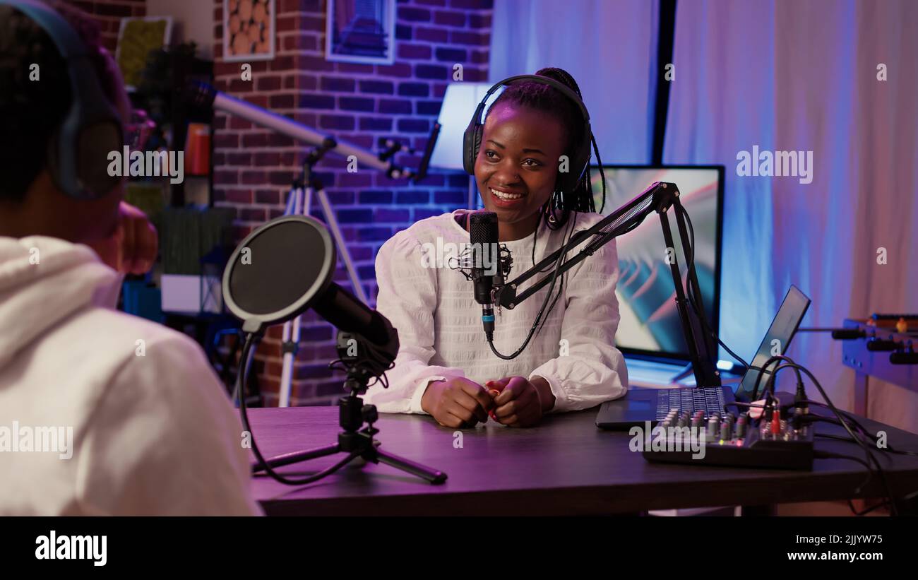 African american couple recording vlog using digital camera while ...