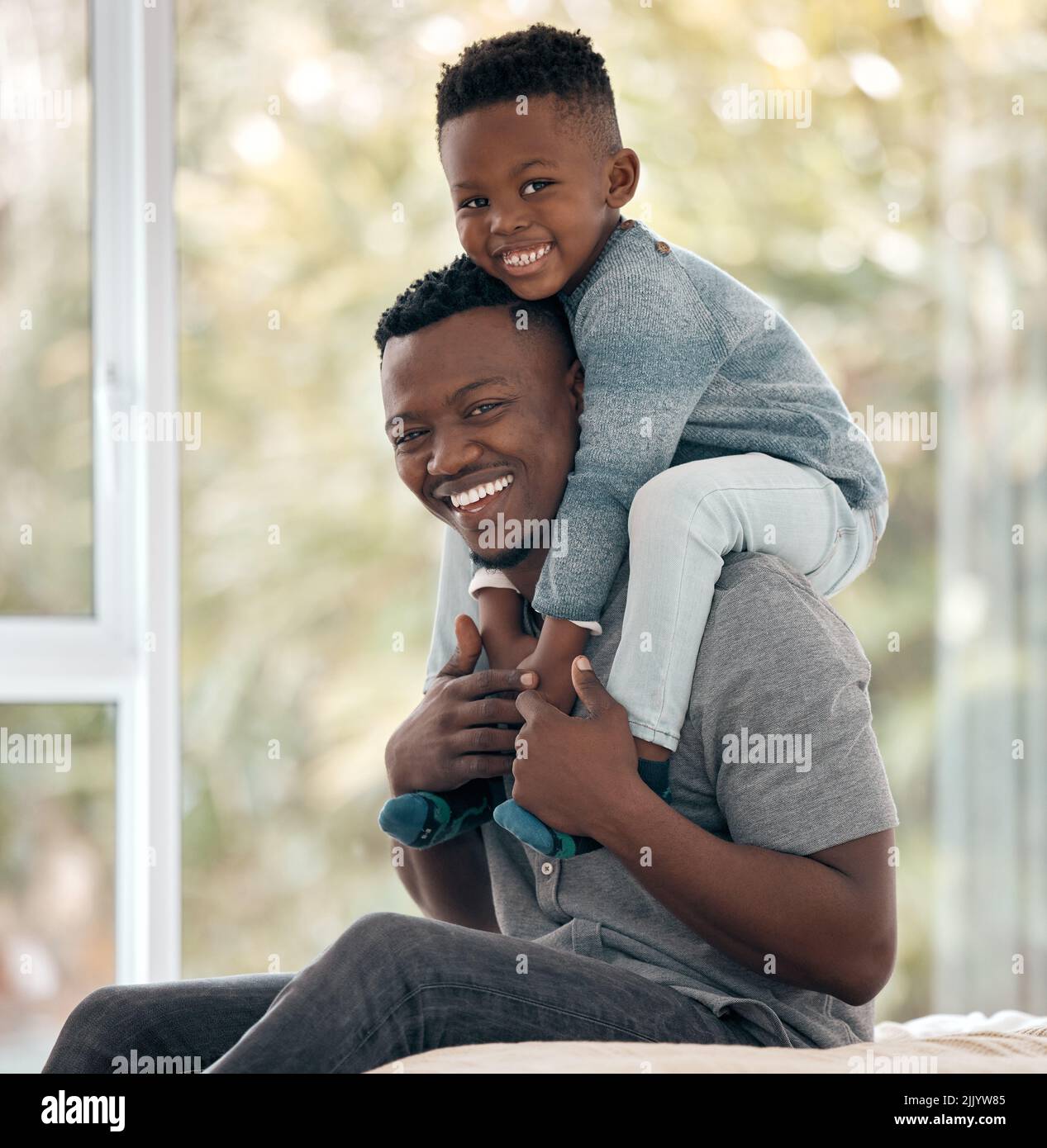 Me and my little man. Cropped portrait of a handsome young man sitting ...