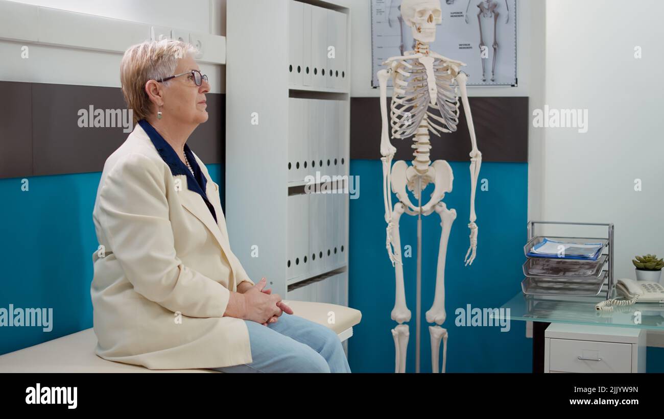 Senior woman waiting to attend medical consultation with doctor in ...