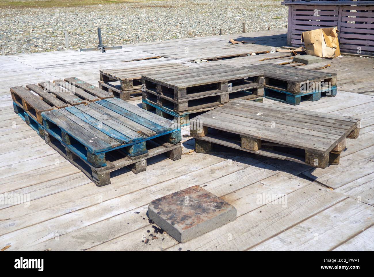 Darkened old pallets. Abandoned building materials. Construction ...