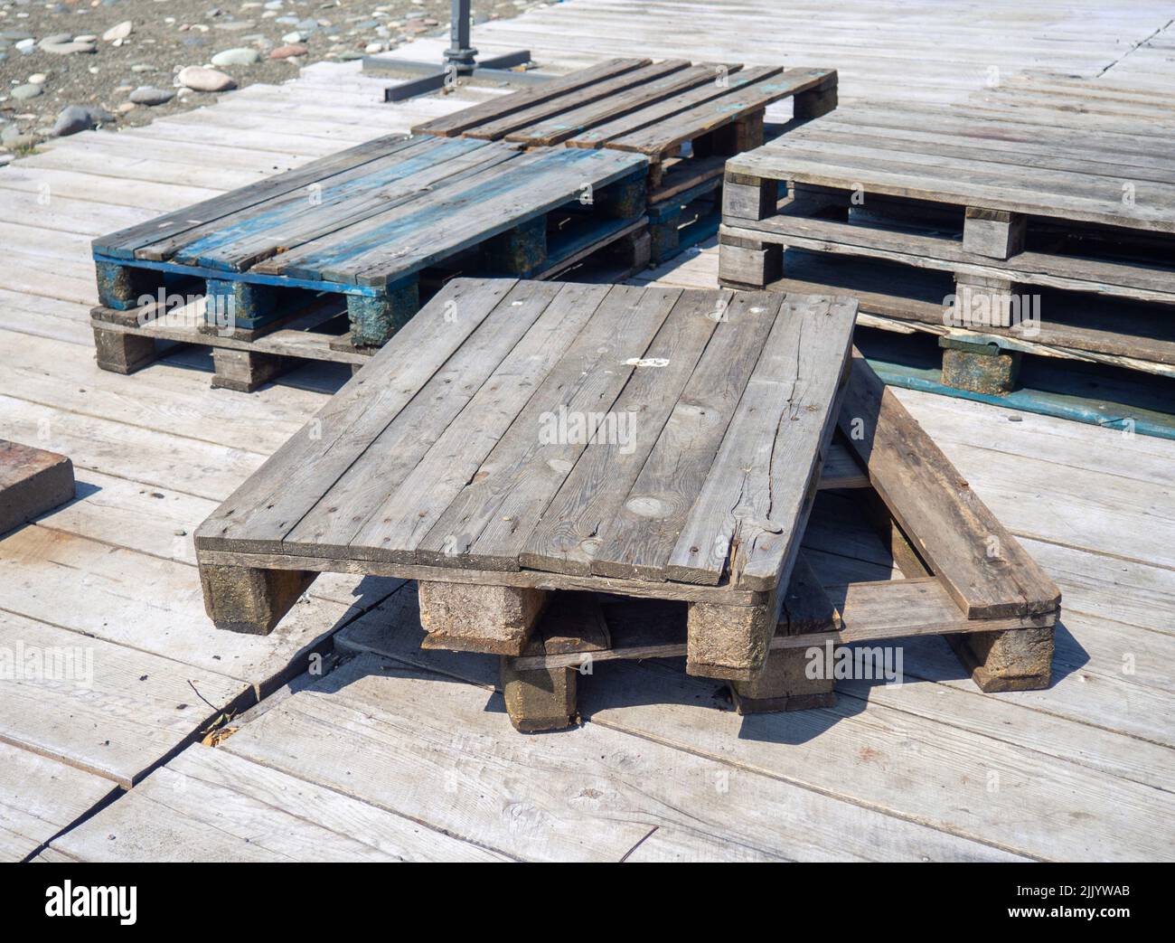 Darkened old pallets. Abandoned building materials. Construction ...