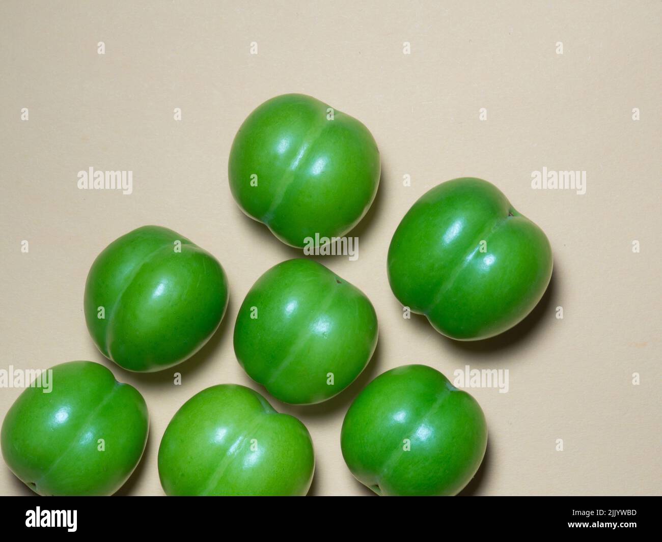 Cherry plum fruits on a beige background. Fruit background. Tkemali ...
