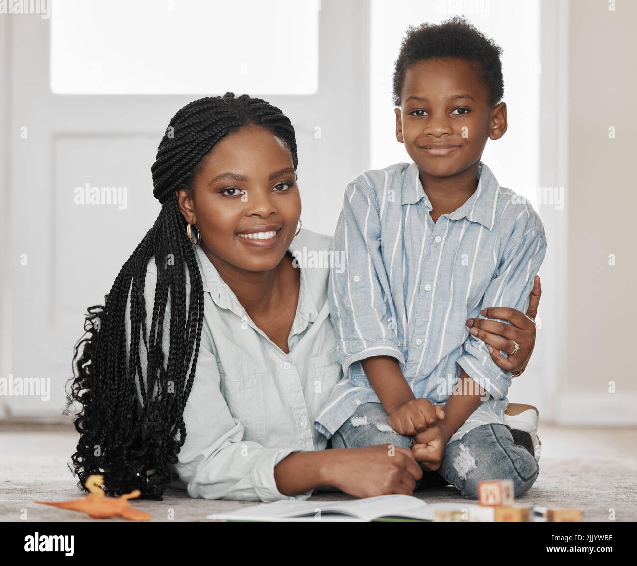 Supervising homework and playtime. Portrait of a mother bonding with ...