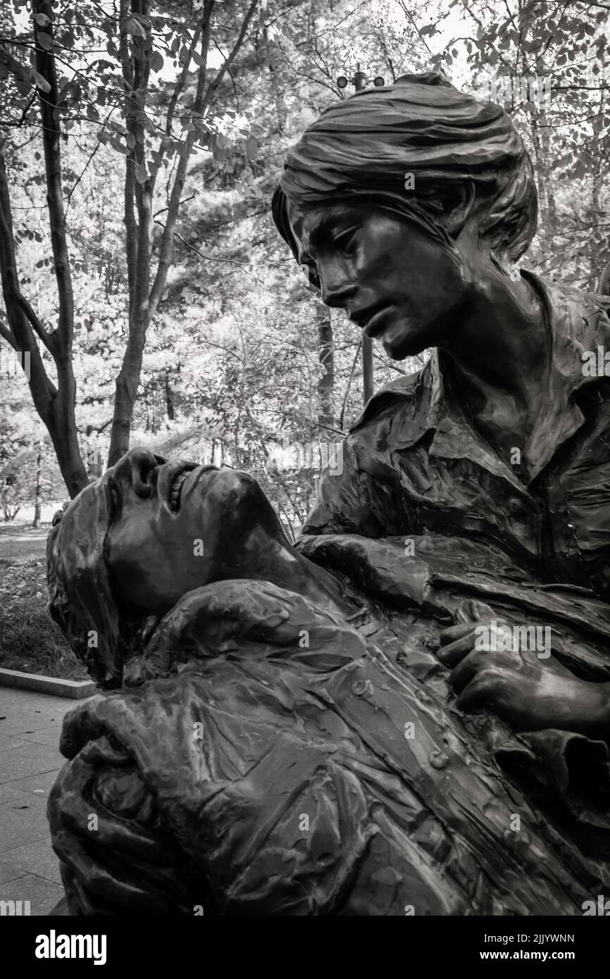 A grayscale a statue of soldier holding a dead man for Powerful Vietnam ...
