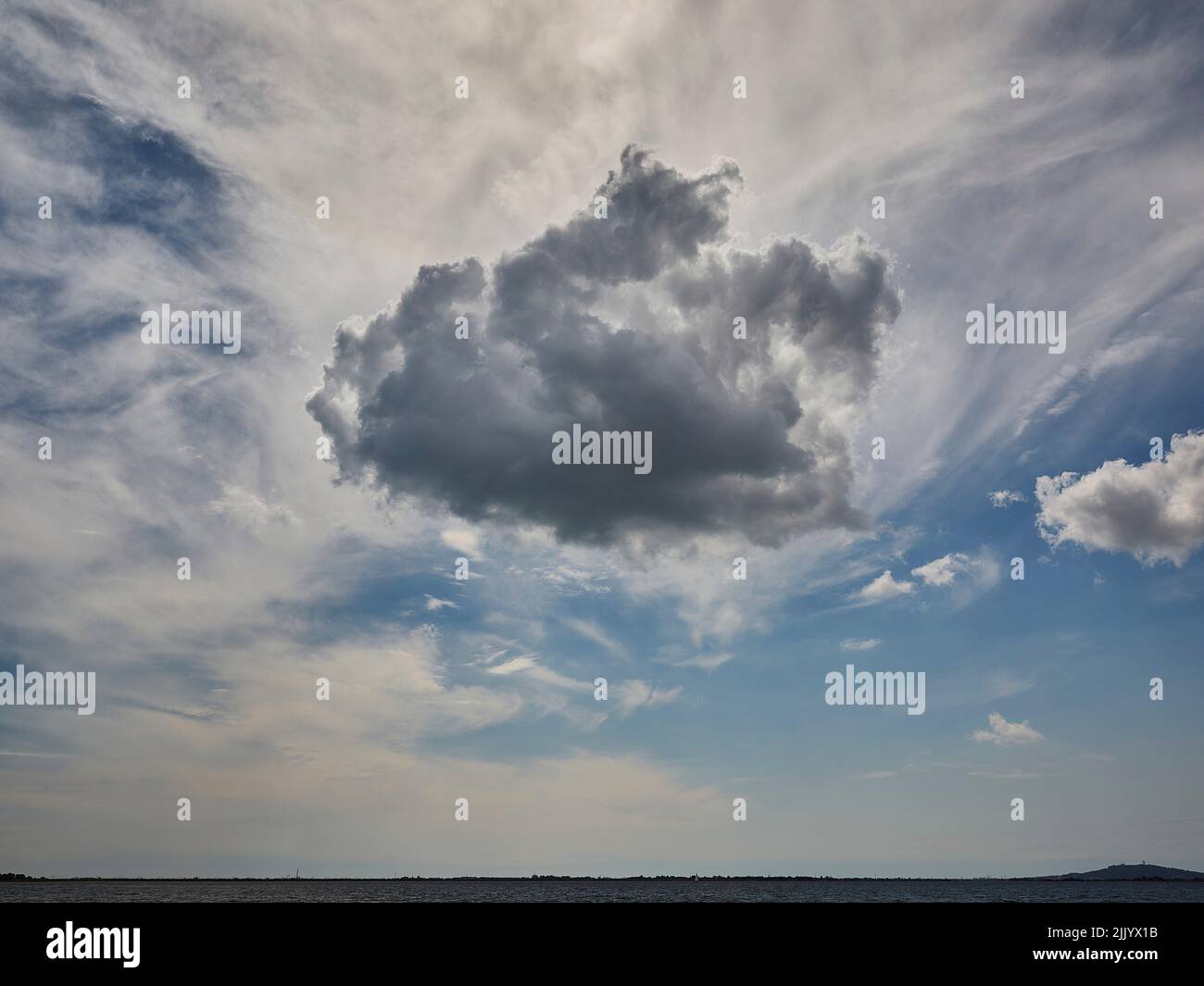 A skyscape with gray clouds above water Stock Photo - Alamy