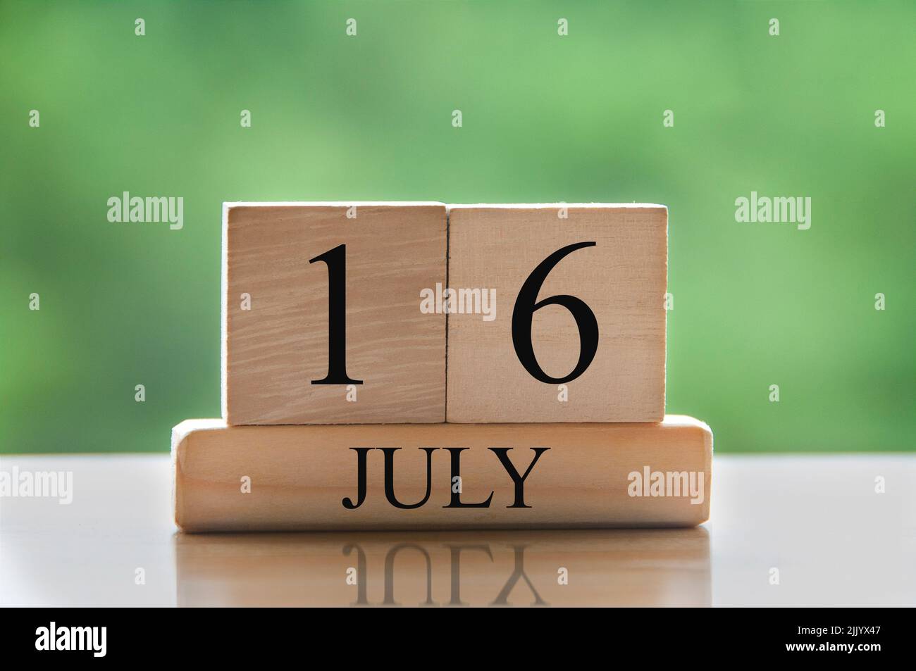 July 16 calendar date text on wooden blocks with blurred background ...