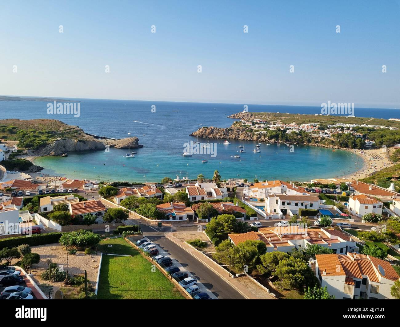 An aerial view of the coastal village in Menorca, Spain during summer ...