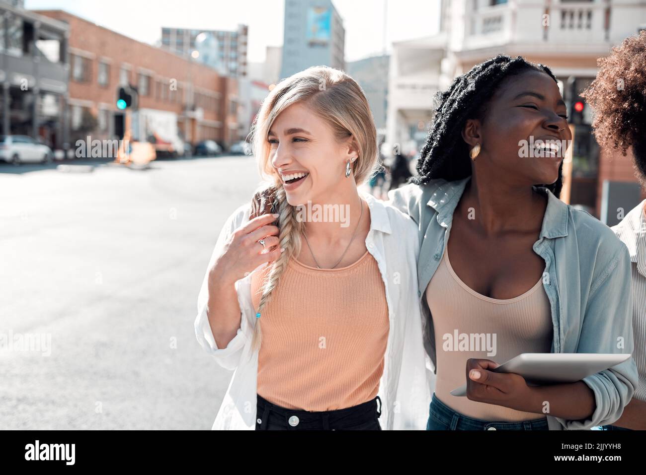 Laughing, happy and trendy students walking together in city after ...