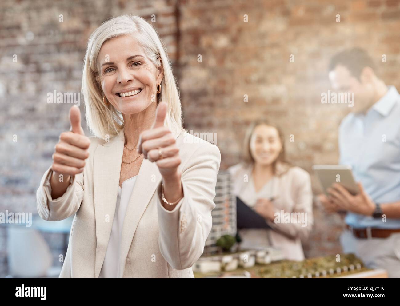 Thumbs up, sign and finger shown by a happy business woman, manager or ...
