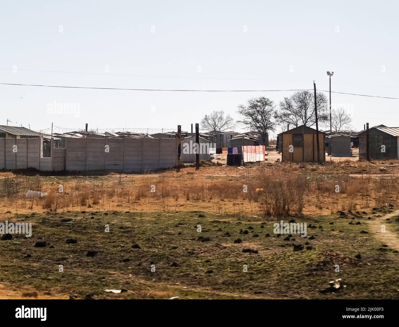 Basic housing for the poor in compound on outskirts of city in South ...