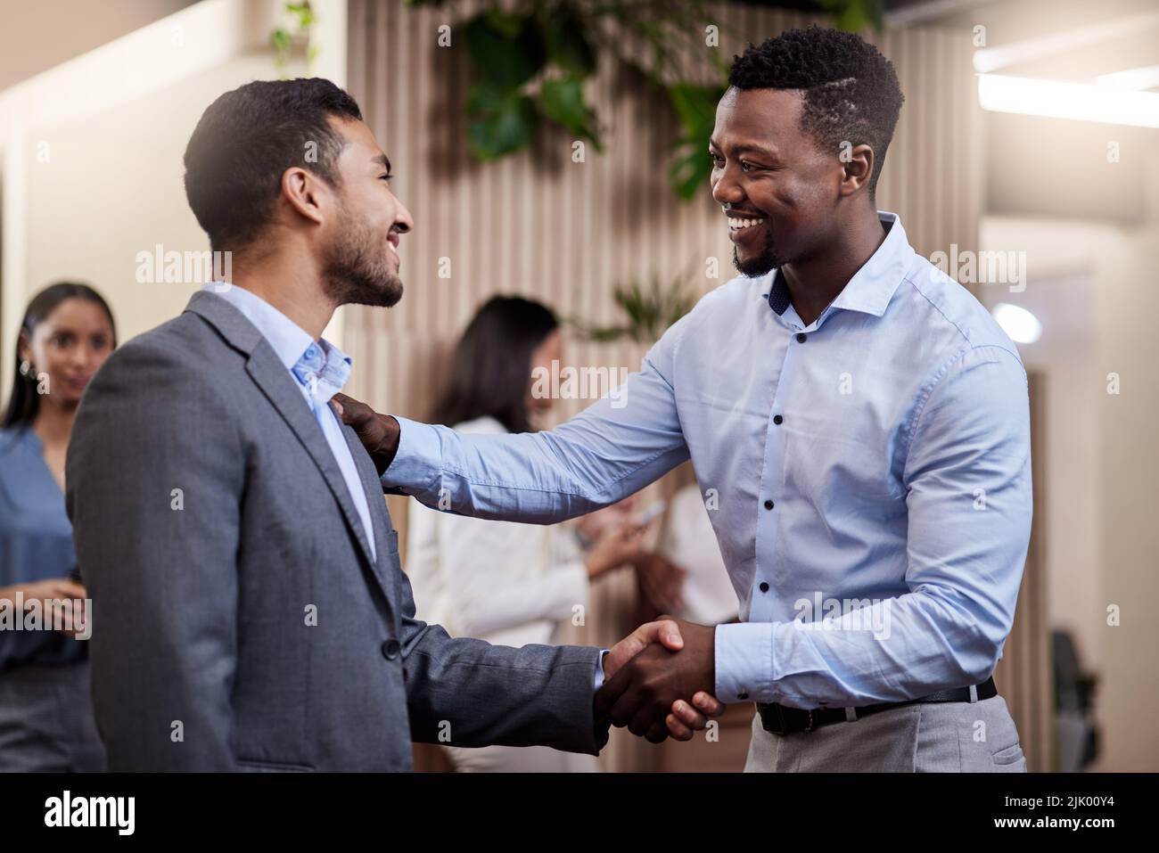 Two brilliant minds collide. two businessmen shaking hands in greeting ...