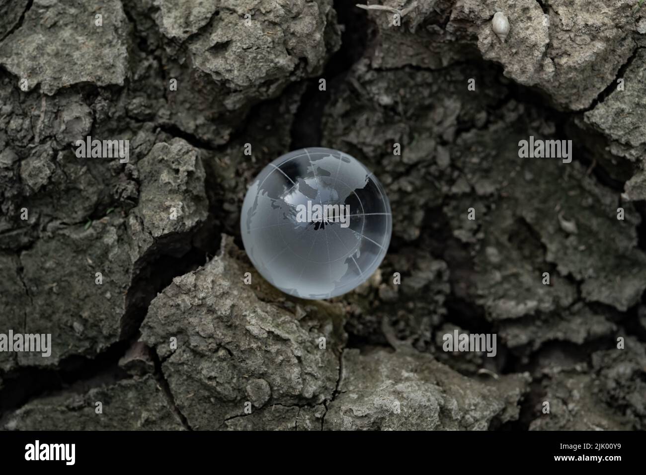 cracked and dried mud with a globe Stock Photo - Alamy