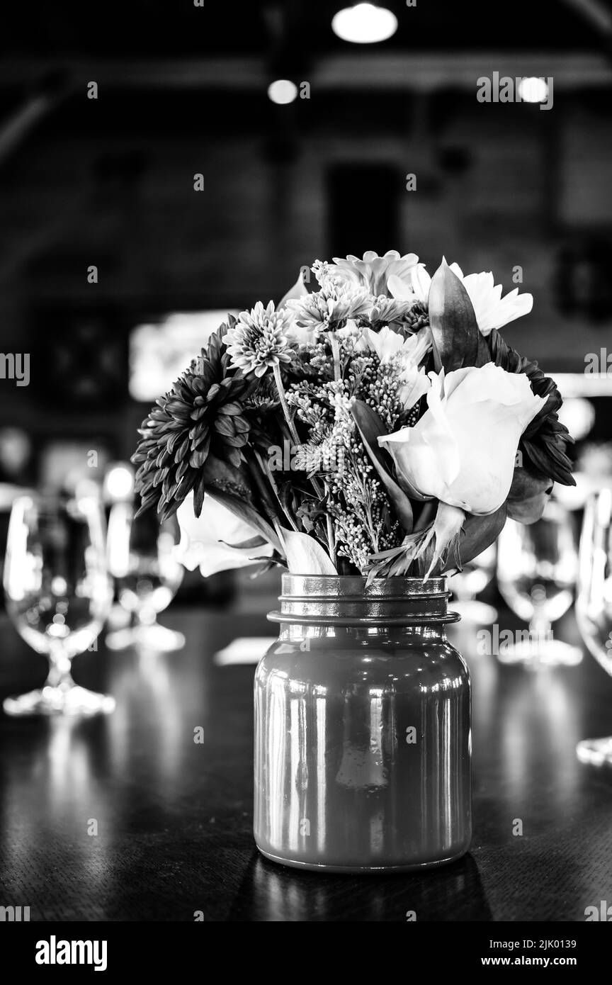 Flower arrangement on a formal dinning table with dim lighting Stock ...