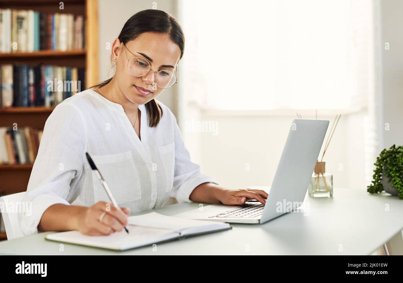 The cure to forgetfulness. a young businesswoman writing in her diary ...