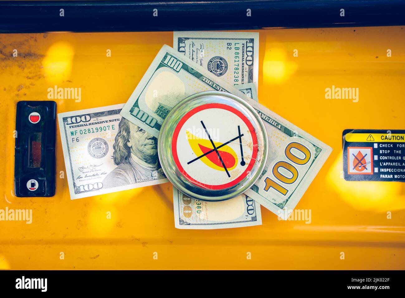 Dollars spent on refueling a tank of fuel. Fuel filler cap pressed ...