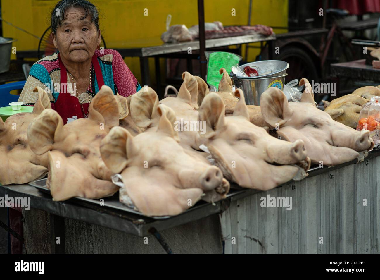 Unidentified Thai vendors selling fresh pork to bring to cook at the ...