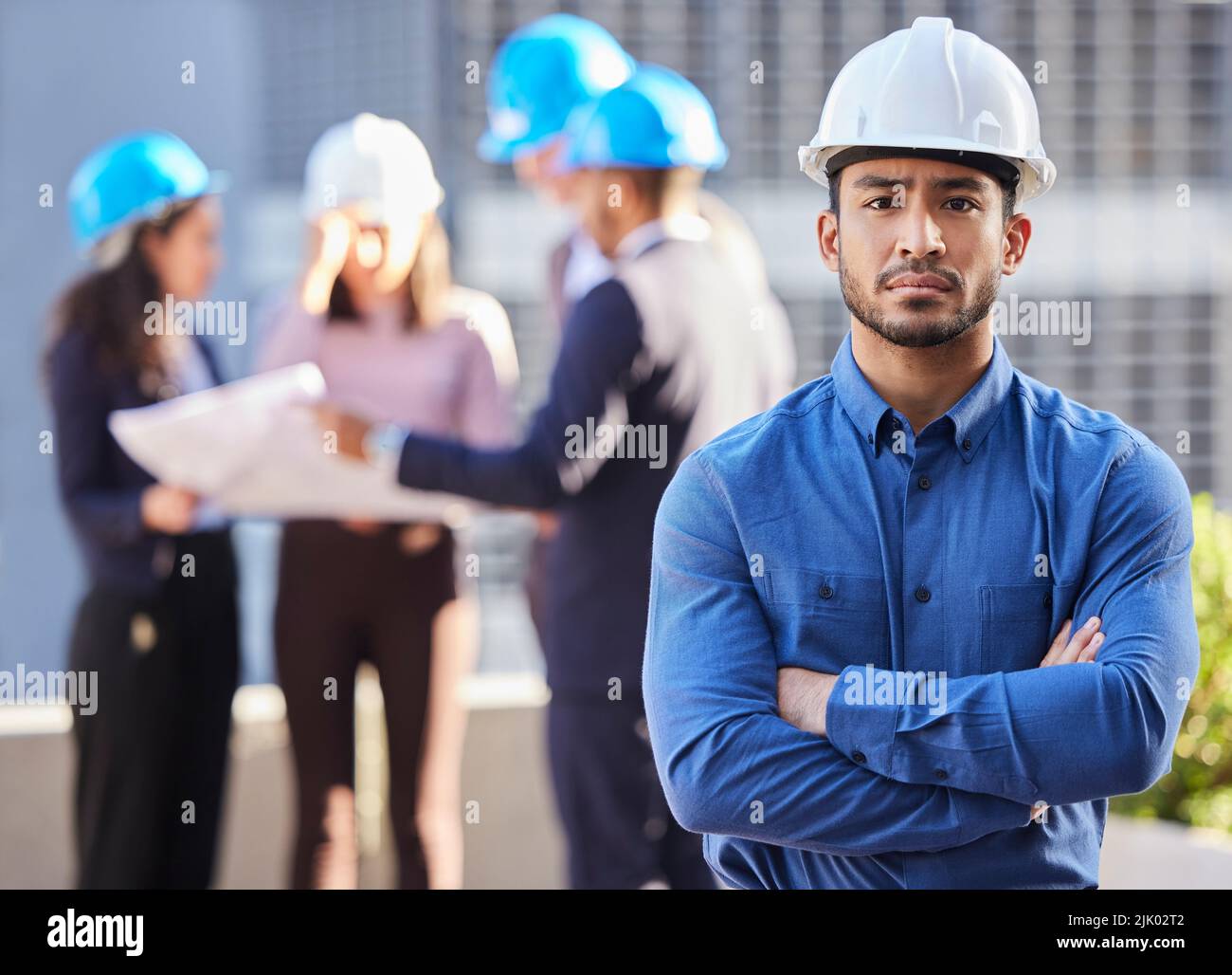 Were ready to get building. a young businessman standing with his arms ...