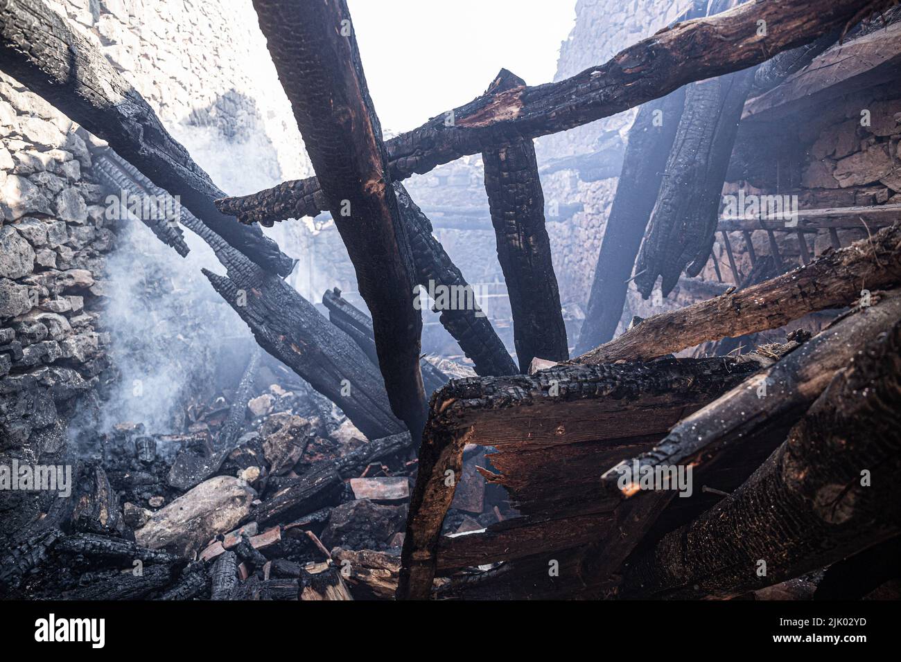 The interior of a burned haystack. A fire has destroyed a large part of ...