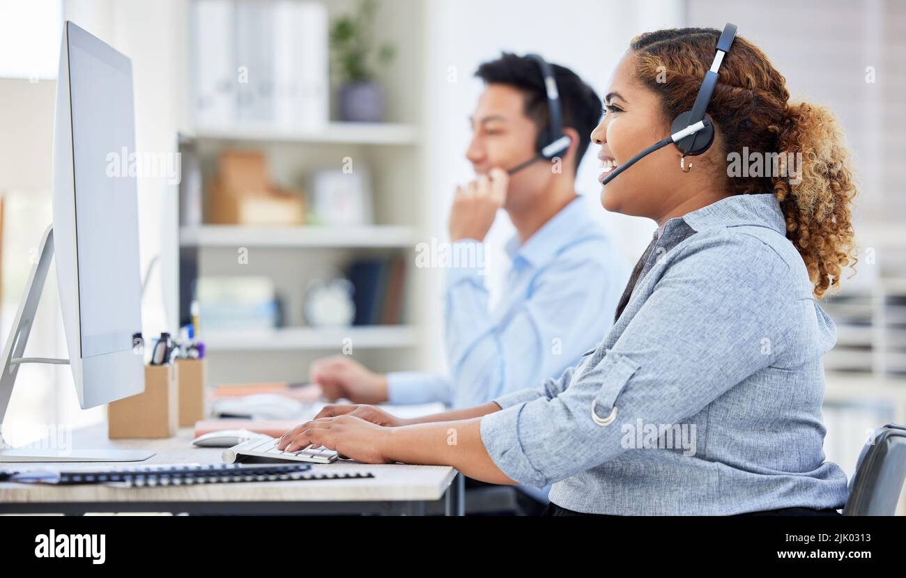 Happy, confident and smiling call centre agent talking on a headset ...