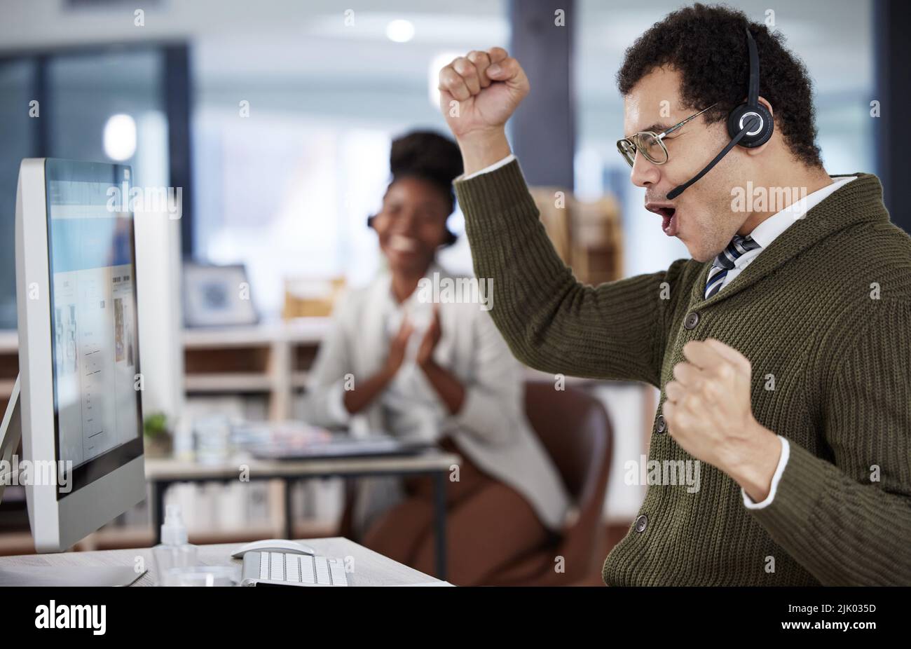 Success is attainable through hard work. a two colleagues celebrating ...