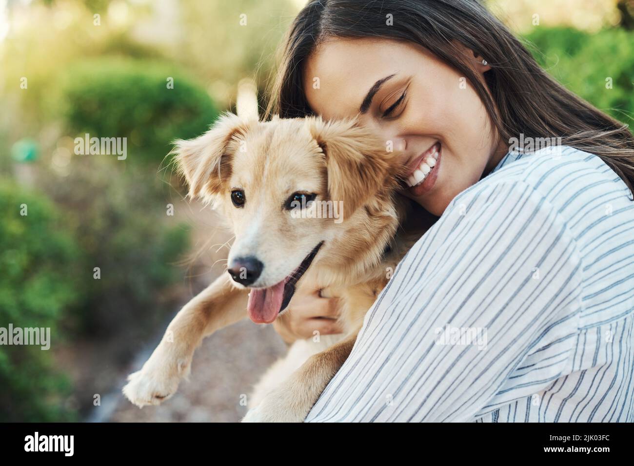 You give the best snuggles. a young woman cuddling her dog Stock Photo ...