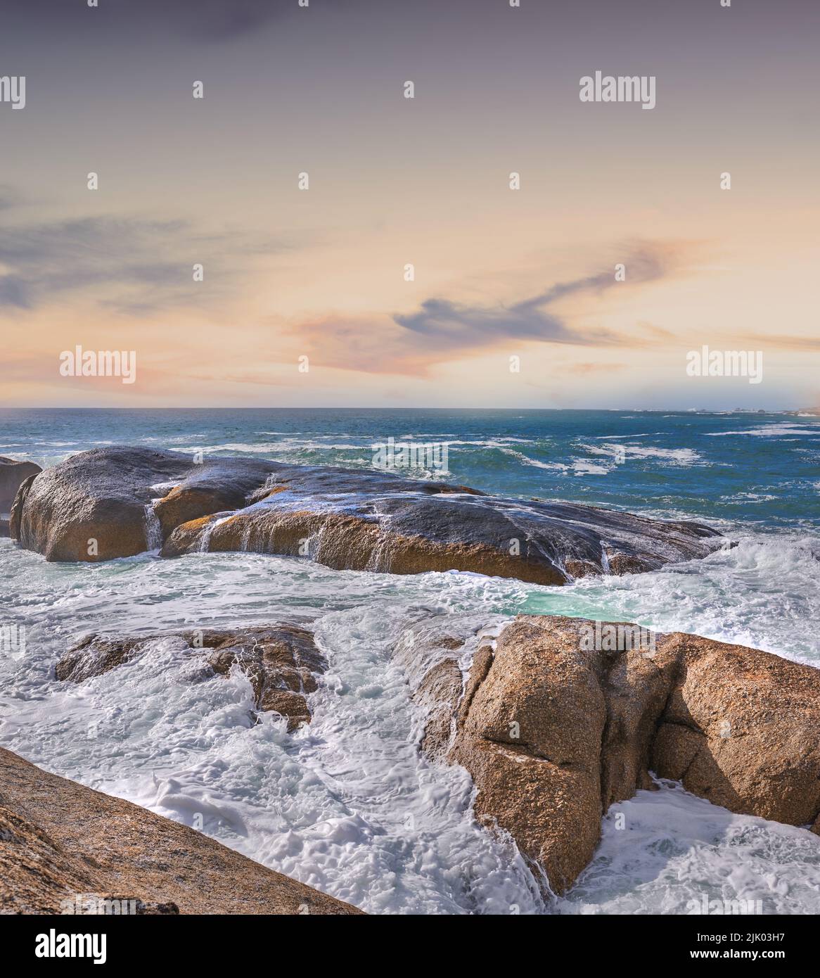 Beautiful, blue ocean view of a sea with a light, colorful sky copy ...