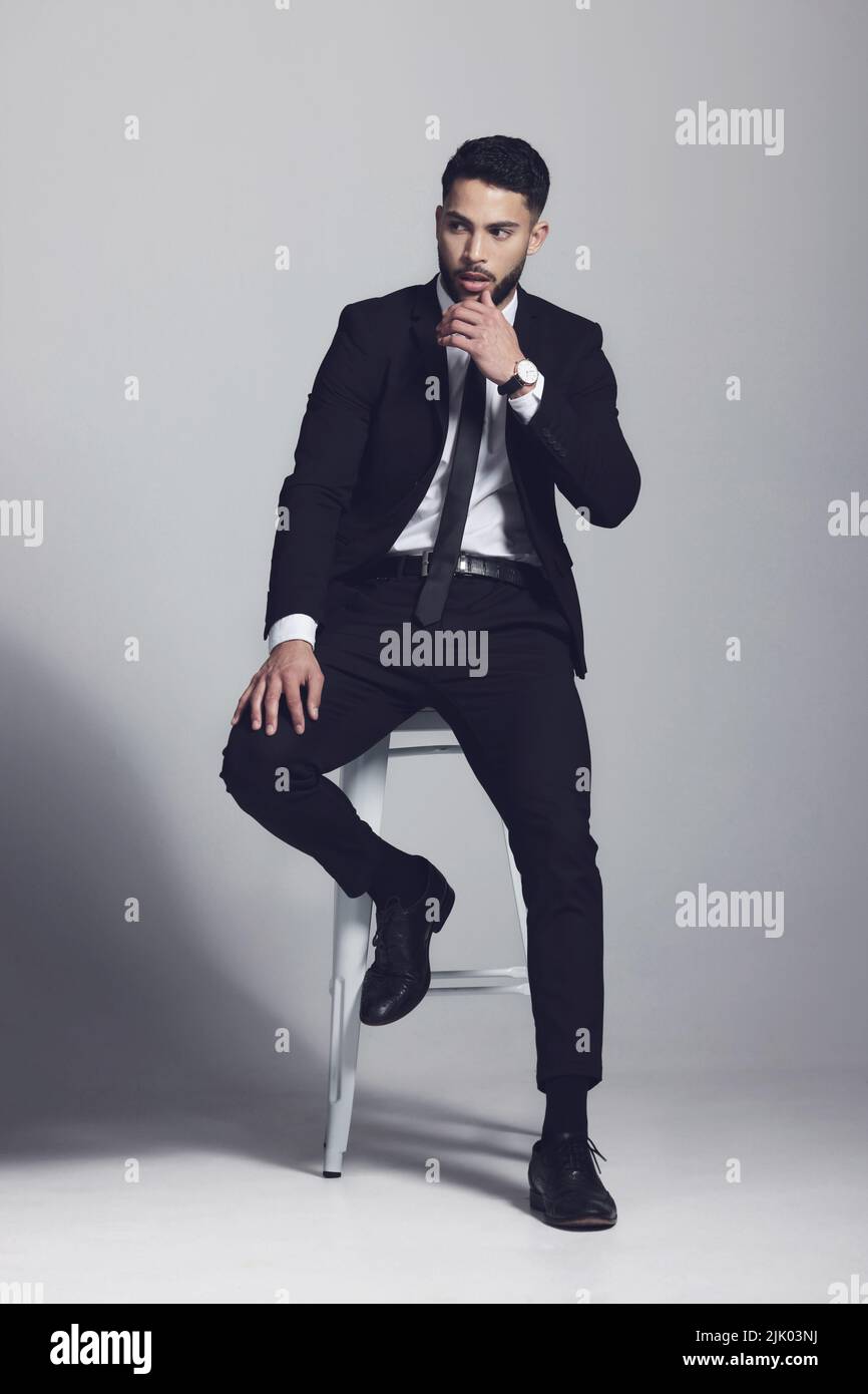 Looking dapper as always. Studio shot of a young man posing against a ...