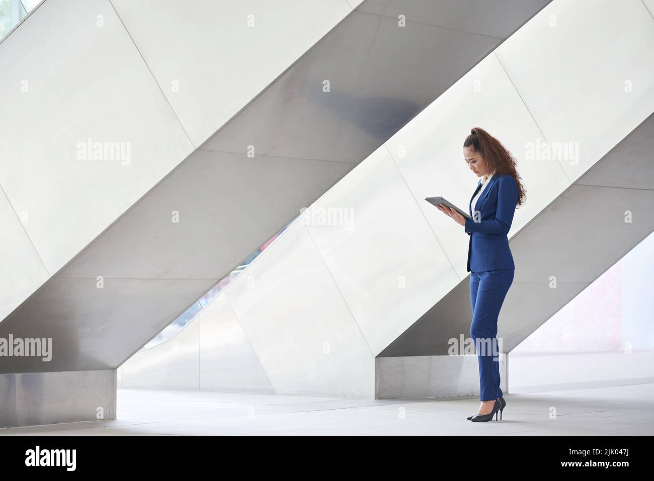 Asian young business woman checking information in business document ...