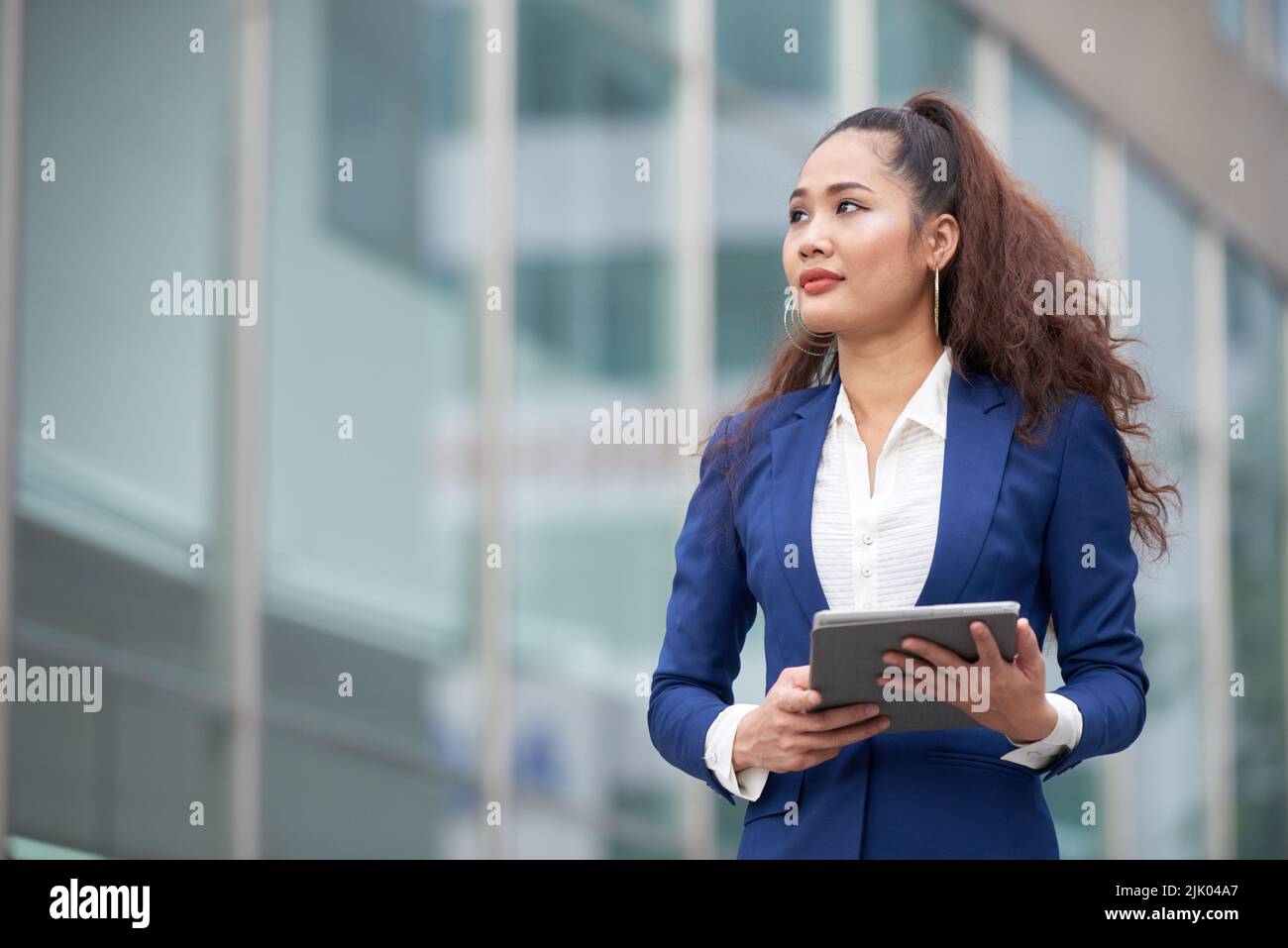 Portrait of pretty Vietnamese business lady with tablet computer Stock ...
