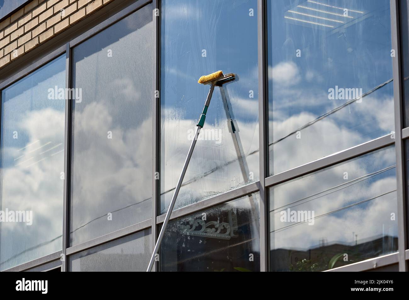 window washing, washing a street shop window Stock Photo - Alamy