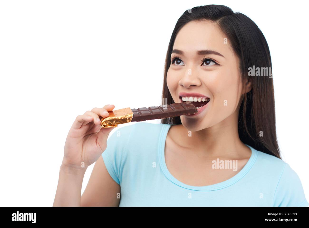 Head and shoulders portrait of smiling pretty woman looking away while ...