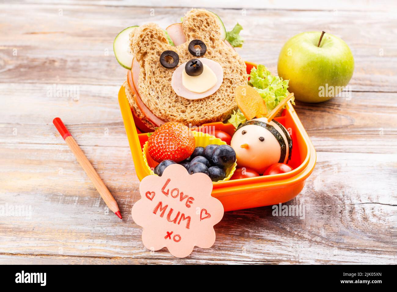 Kids lunch box with funny bear sandwich and boiled egg bee, apple ...