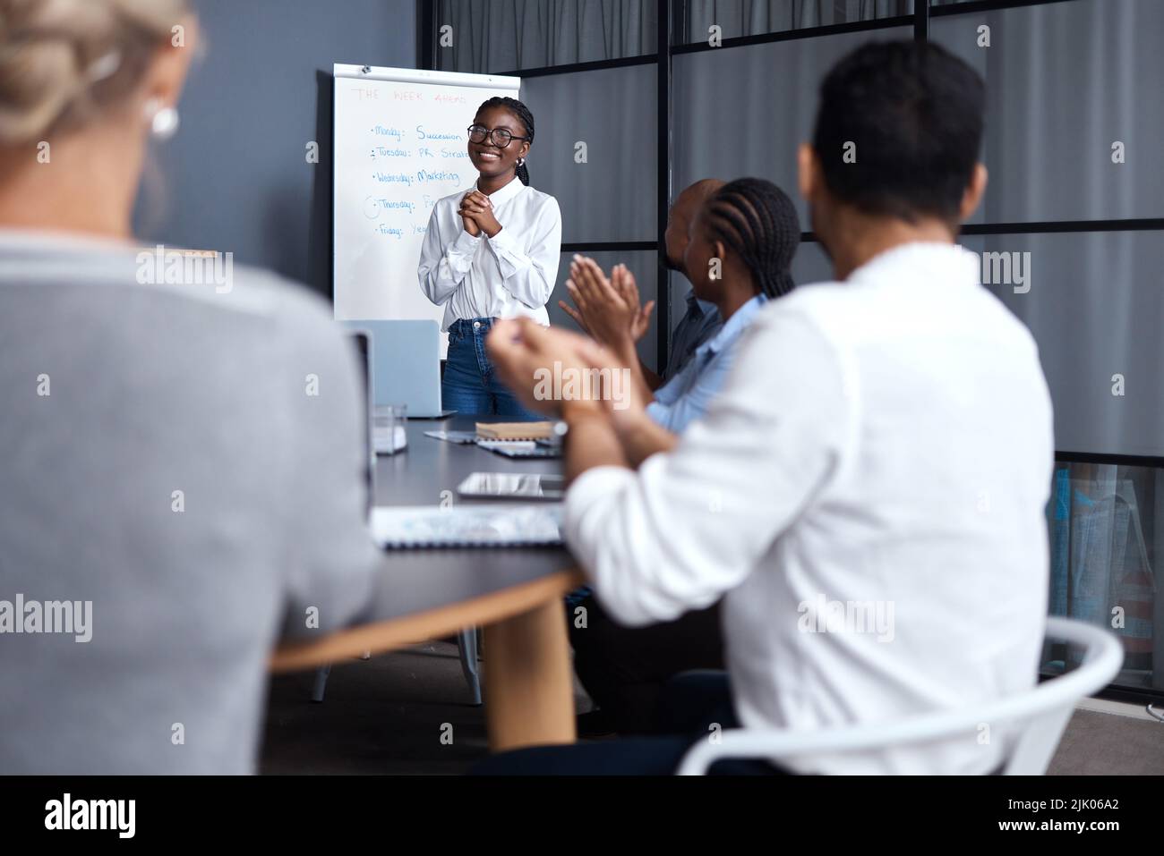 She did great. a group of businesspeople clapping hands in a meeting at ...