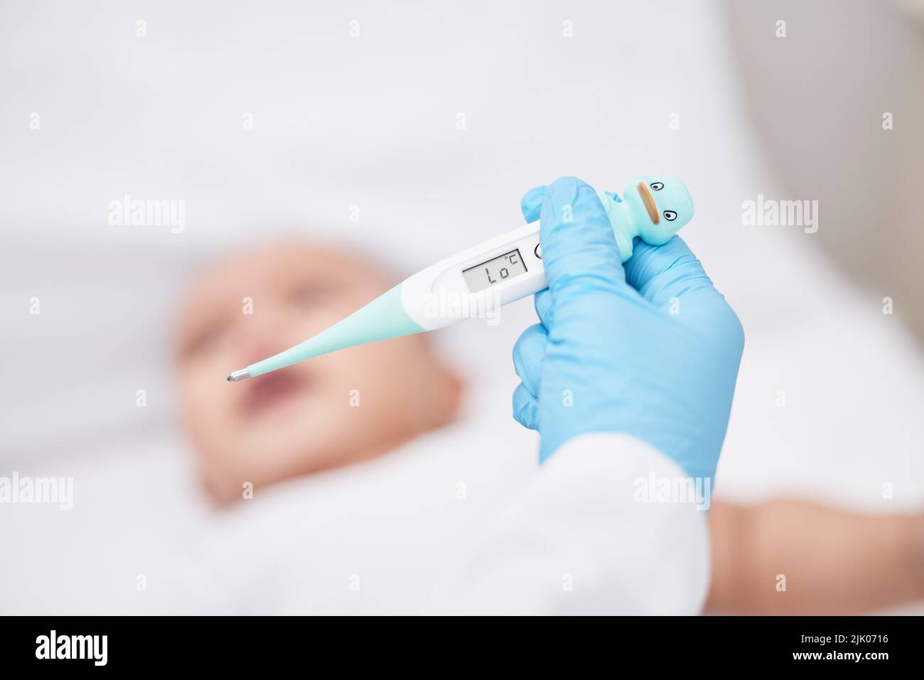 Time for a checkup. a unrecognizable doctor taking a babys temperature ...