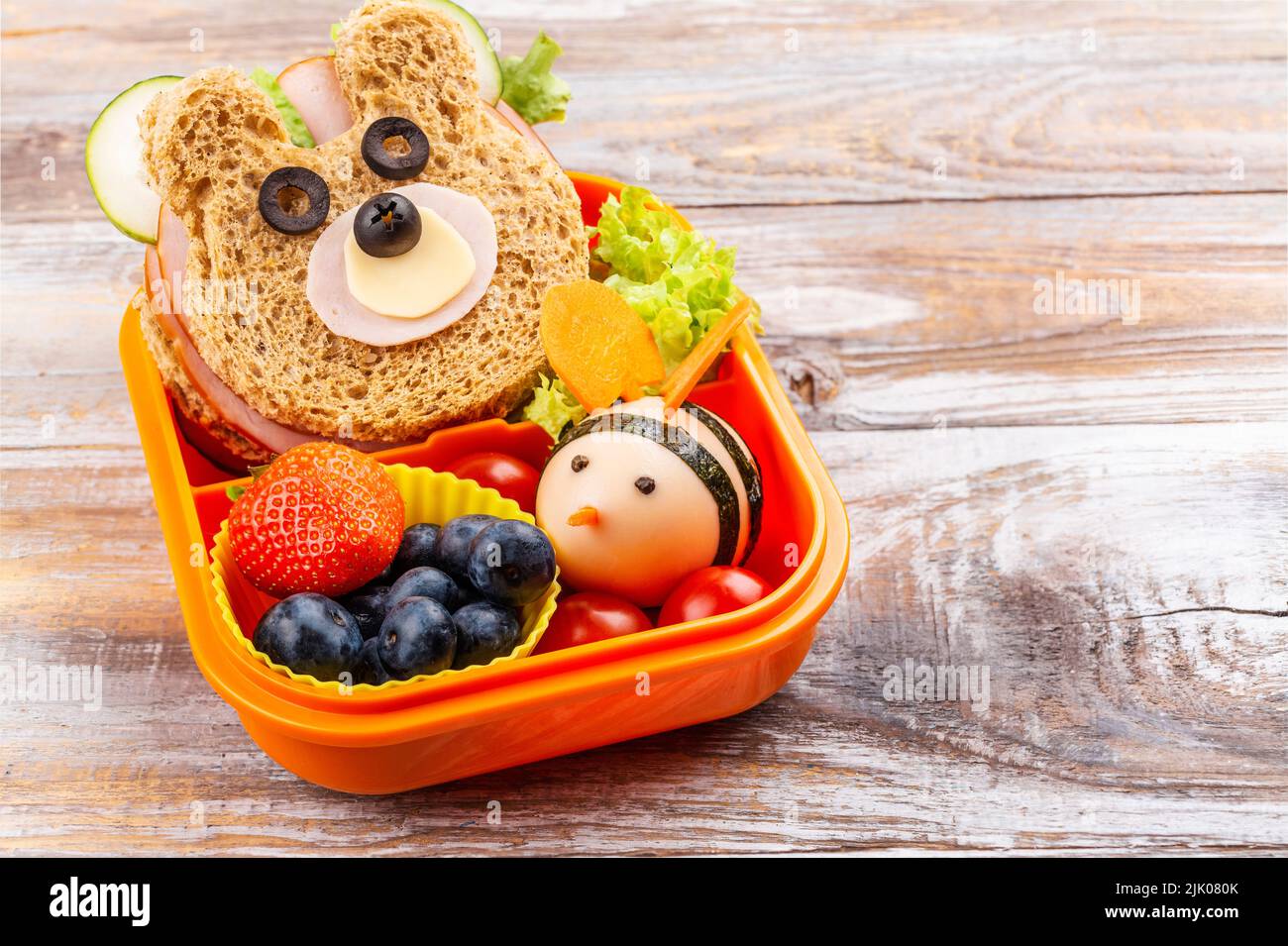 Kids lunch box with funny bear sandwich and boiled egg bee, apple ...