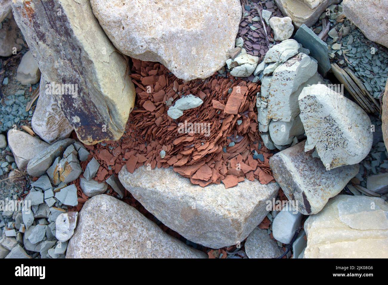 A stone crumbled into small pieces by the river Stock Photo - Alamy