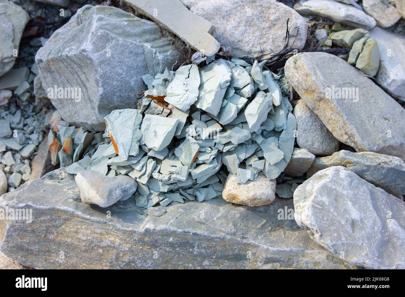A stone crumbled into small pieces by the river Stock Photo - Alamy
