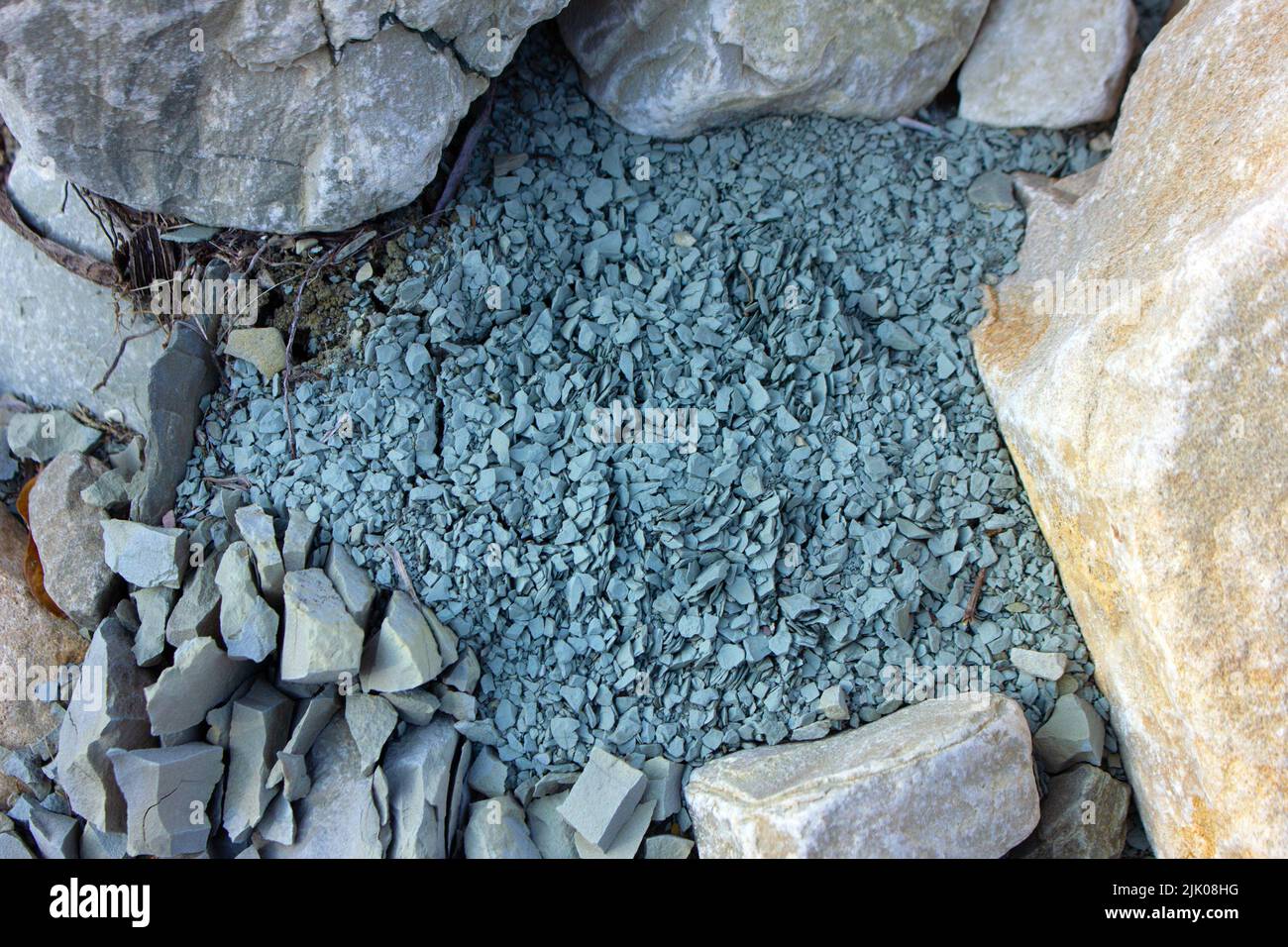 A stone crumbled into small pieces by the river Stock Photo - Alamy