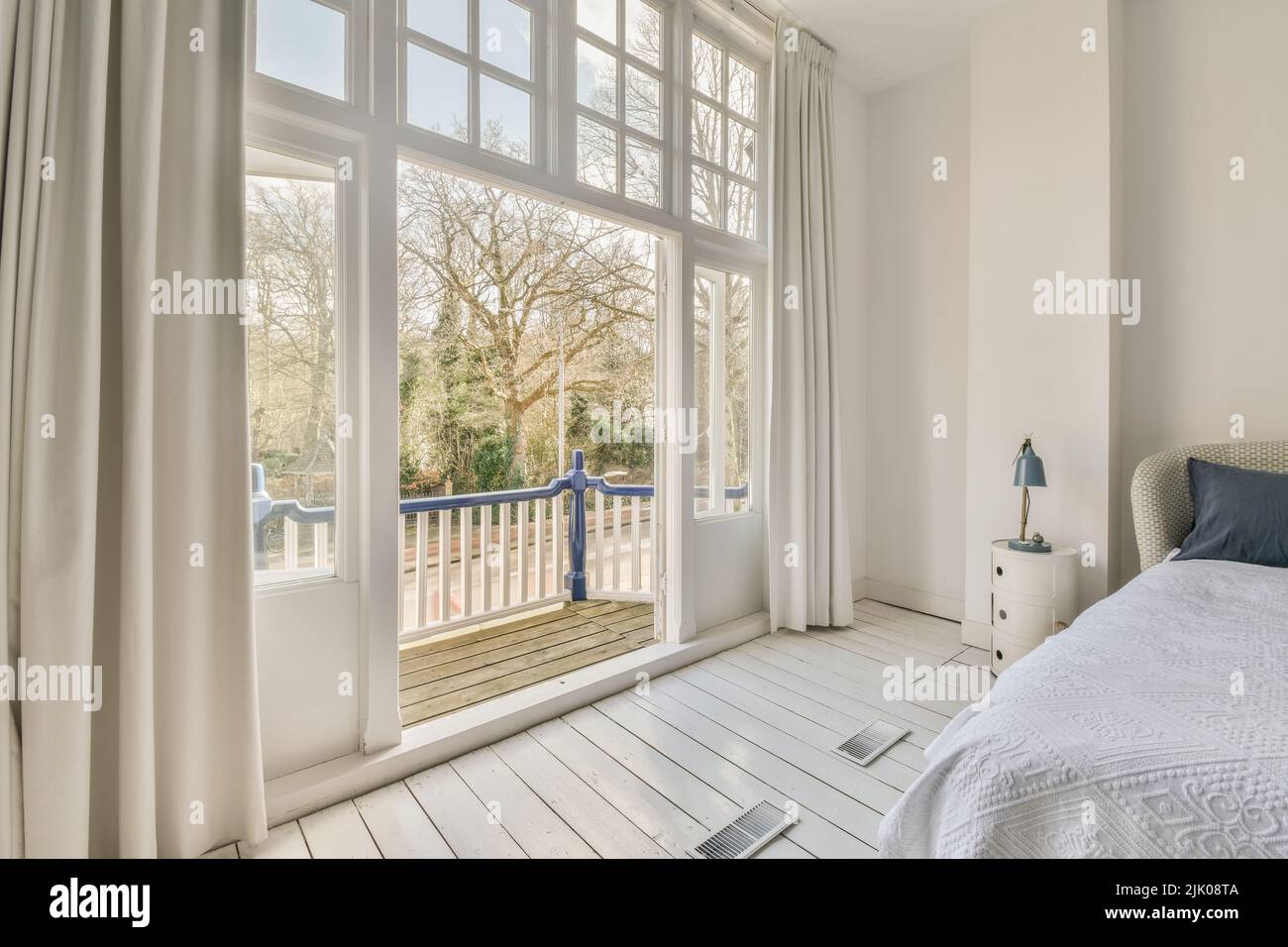 Home interior design of bedroom with bed and wooden wardrobe placed in ...