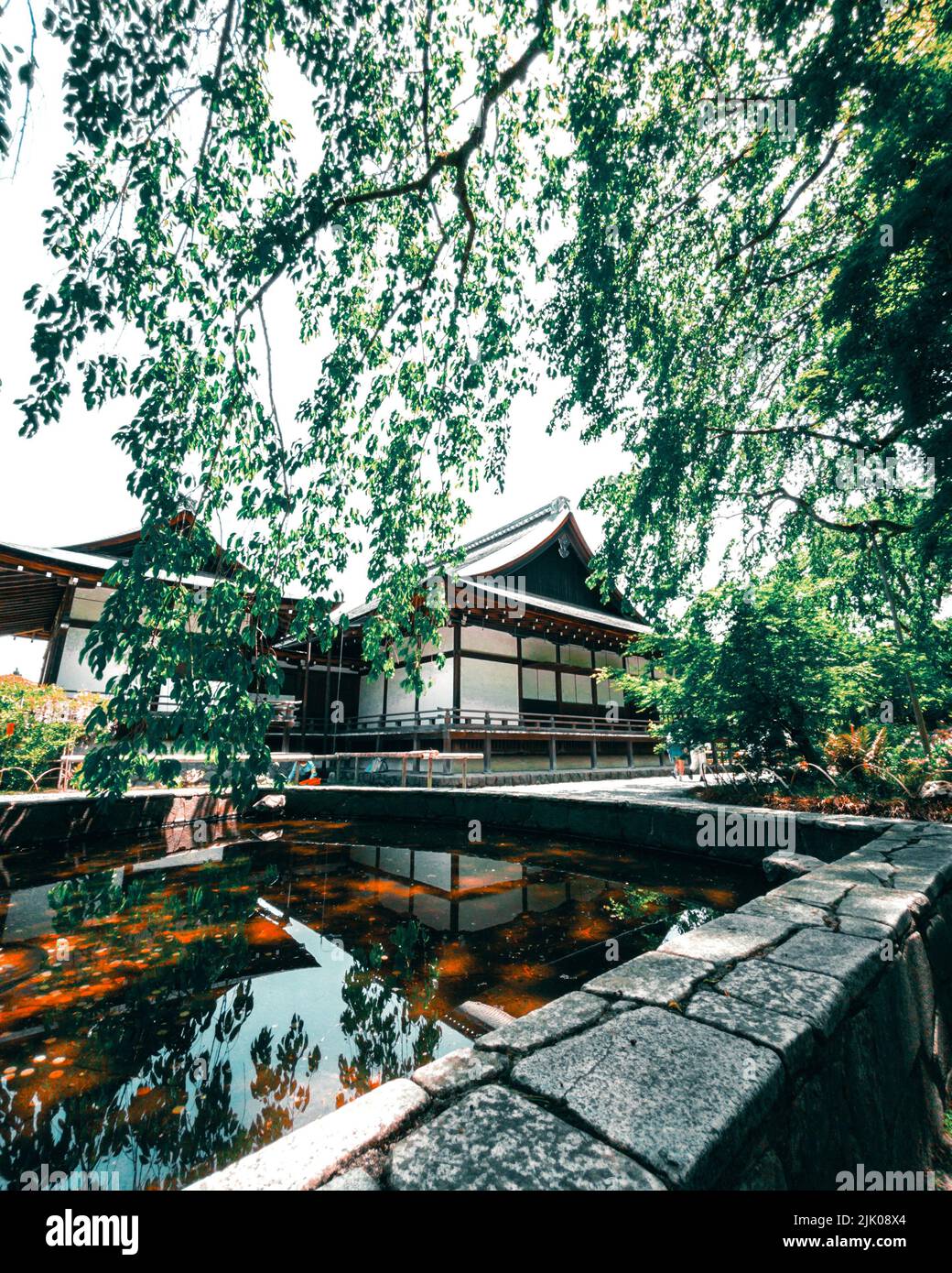 A view of park with stony pool in background of buildings in Japan ...