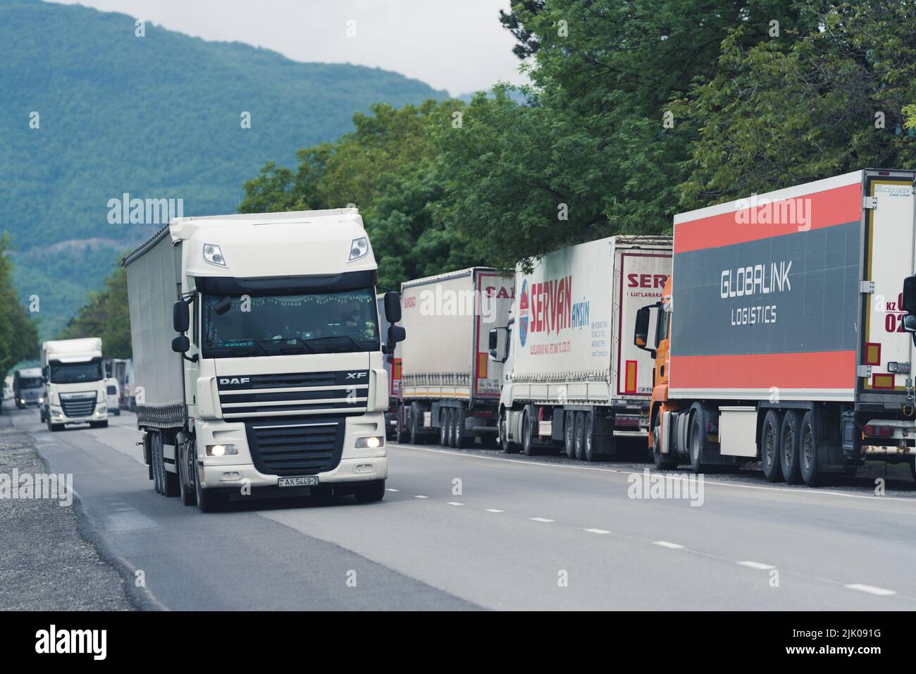 05.16.2022 Georgia. Long queue of transit trucks standing one after ...