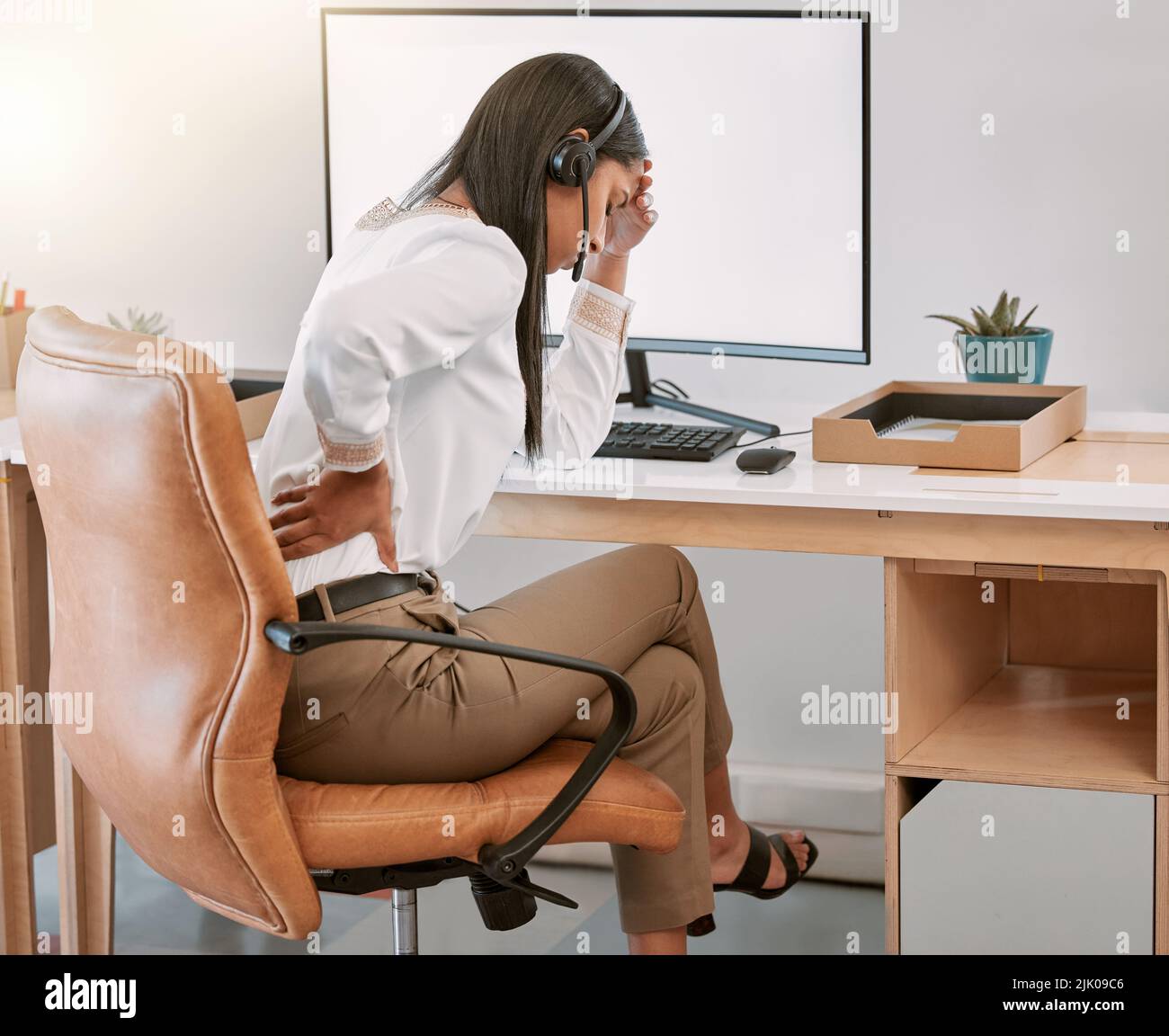 Back pain will put an end to productivity. Rearview shot of a female ...