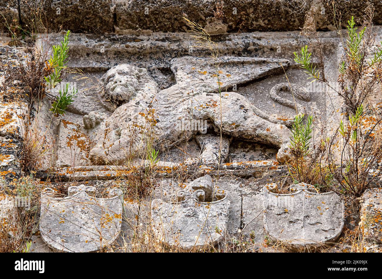 ancient heraldic crest cast in stone above the door of an ancient greek ...