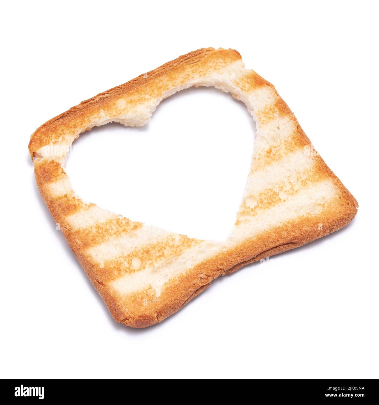 Toasted bread with grill marks and heart shaped hole isolated on white ...