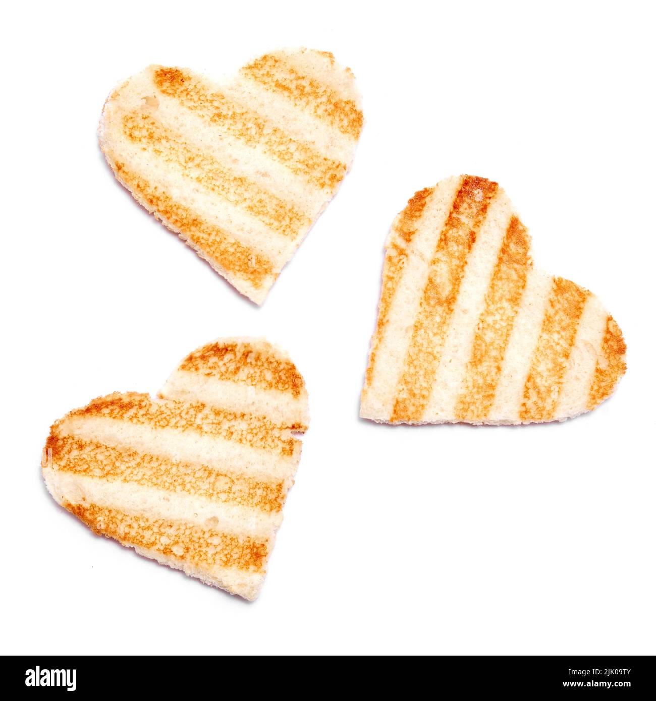 Toasted heart shaped bread with grill marks isolated on white ...