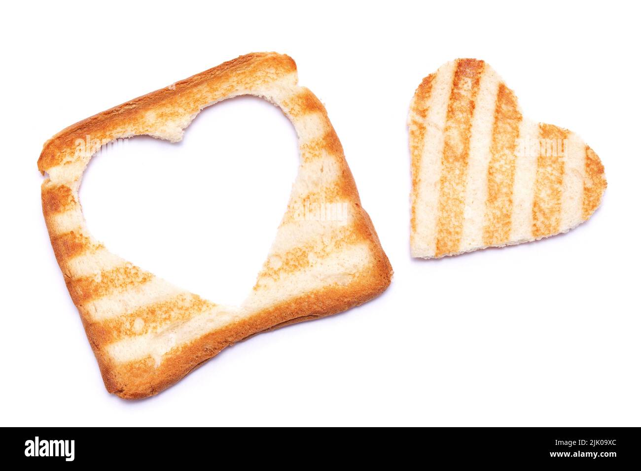 Toasted bread with grill marks and heart shaped hole isolated on white ...