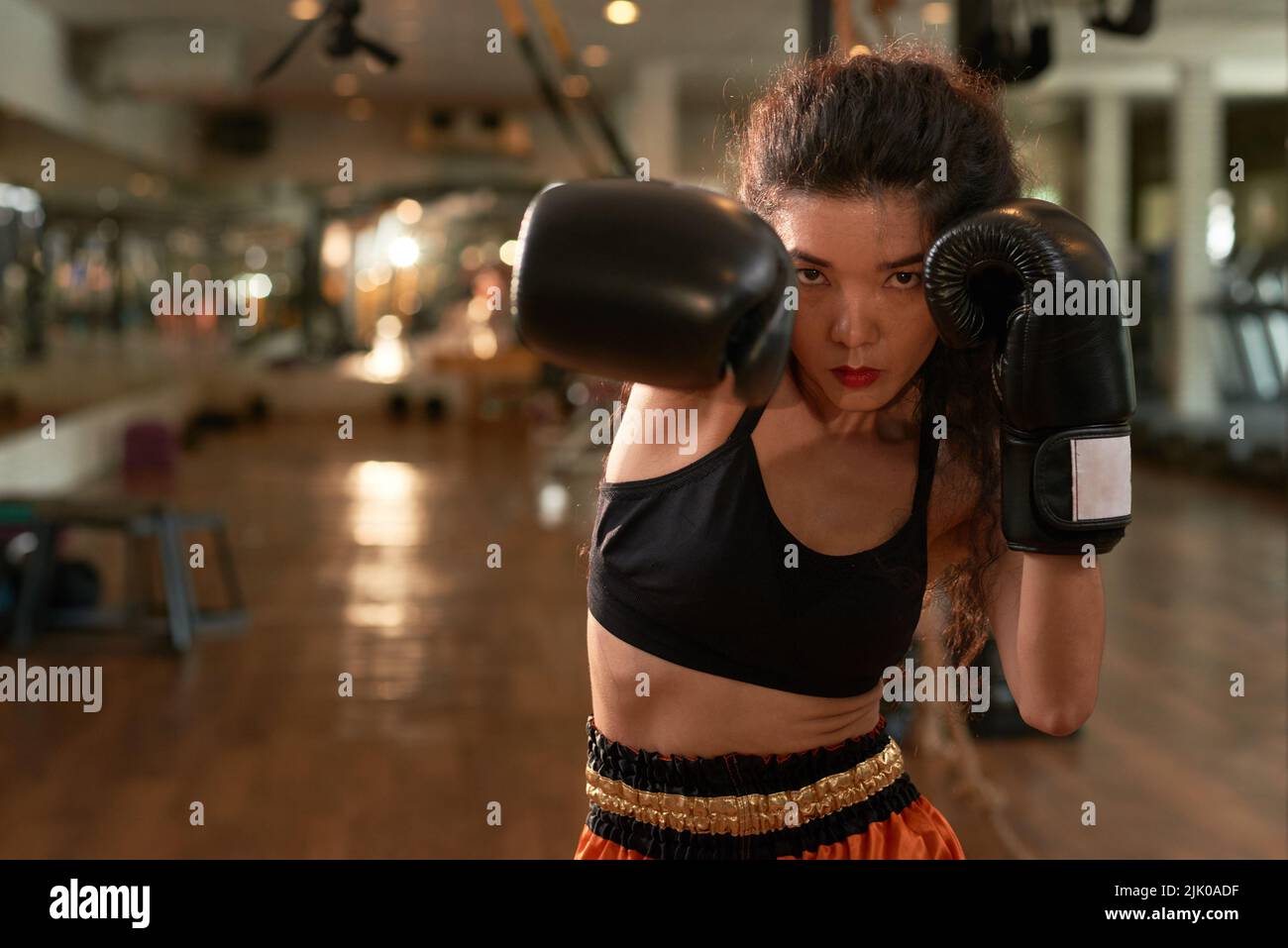 Pretty Vietnamese female boxer training in gym Stock Photo - Alamy