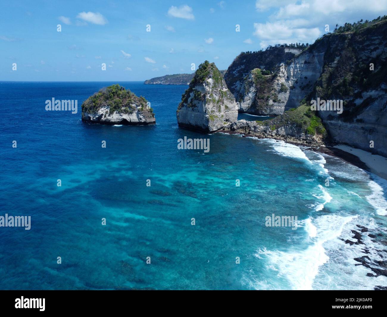 Aerial photo of Nusa Penida bay, white waves and crystal clear water in ...