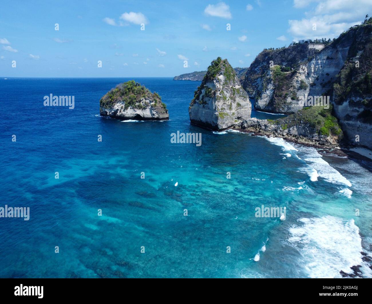 Aerial photo of Nusa Penida bay, white waves and crystal clear water ...